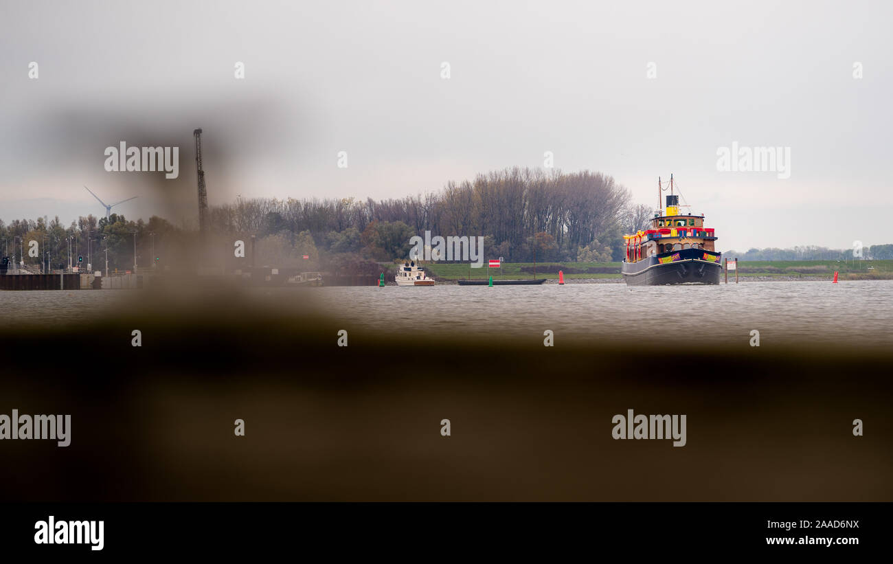 Traditional steamboat sailing on the water with festive clothing and ...
