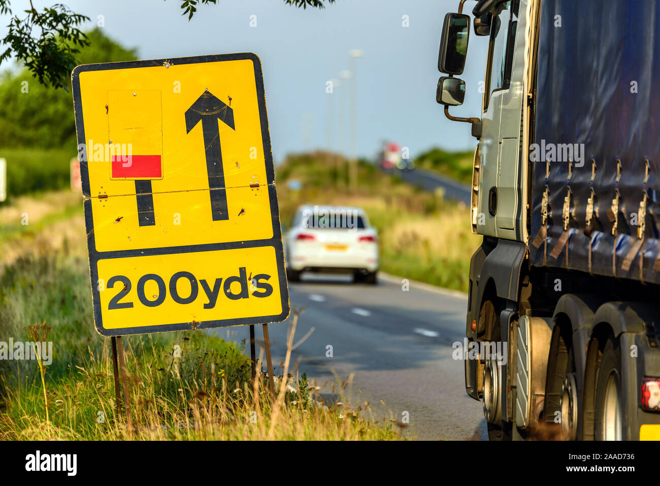 200 yards roadworks warning sign on UK motorway at evening with traffic ...