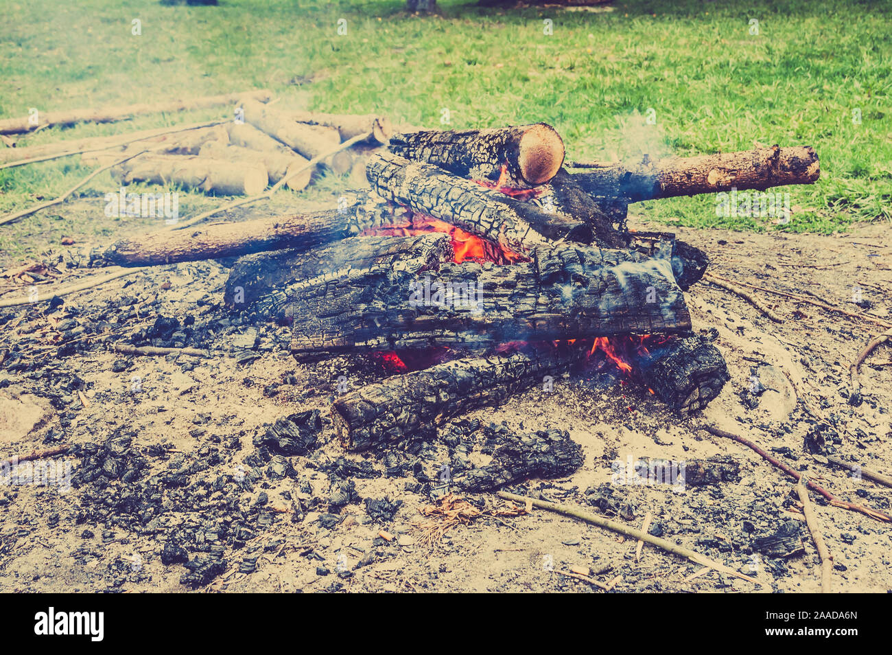 Rustic bonfire outdoors, vintage photo Stock Photo - Alamy