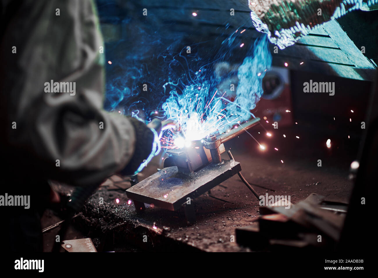 Industrial factory weld worker. Welding or welder master weld the steel ...