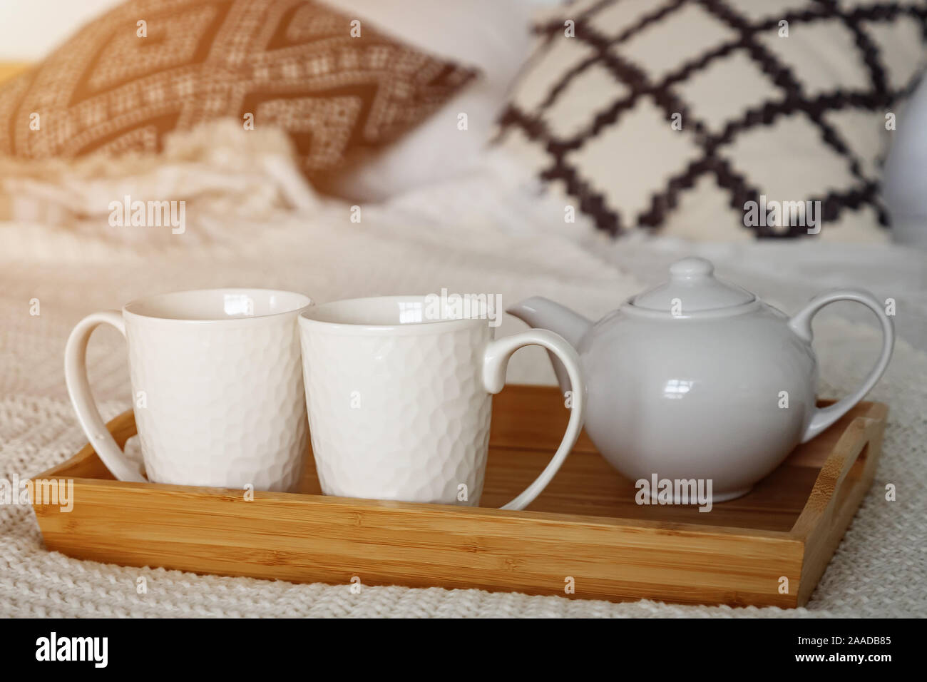 tray of white tea set on bed in bedroom, sunlight Stock Photo - Alamy