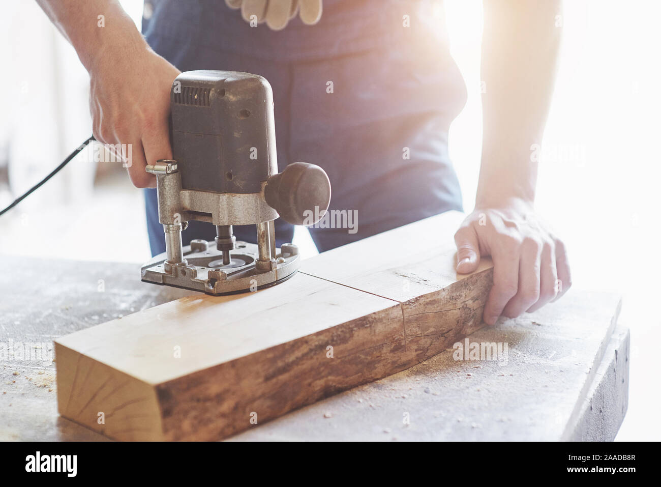 Strong young worker working in the woodworking industry Stock Photo - Alamy