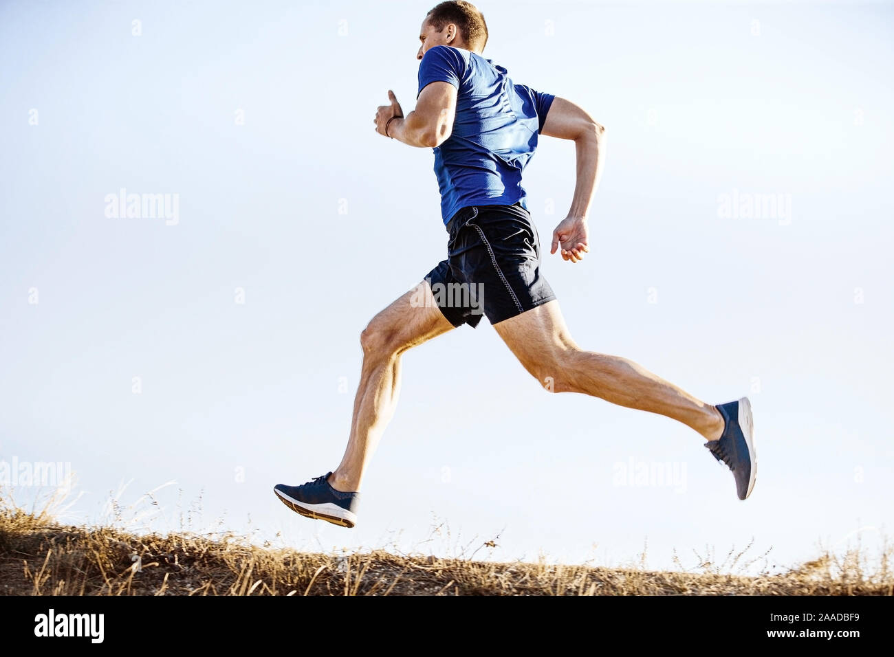 dynamic running trail male runner on light background Stock Photo - Alamy