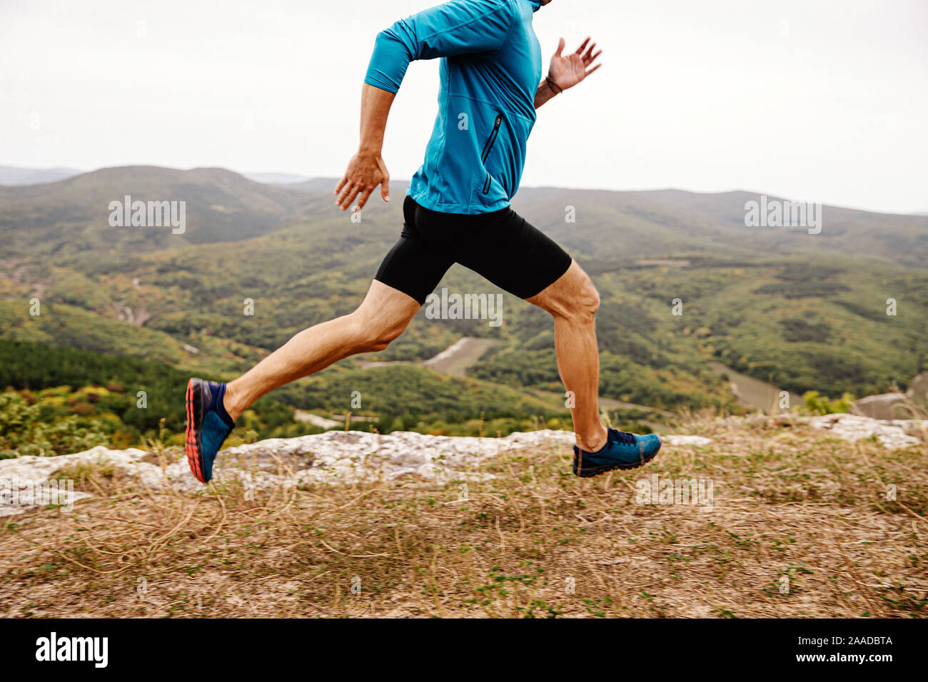 man runner run mountain trail on edge of cliff Stock Photo - Alamy