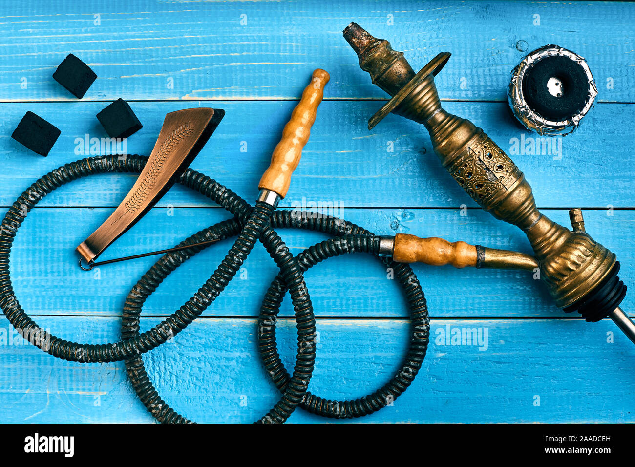 Parts of the hookah on blue wooden background. Hookah accessorie Stock ...