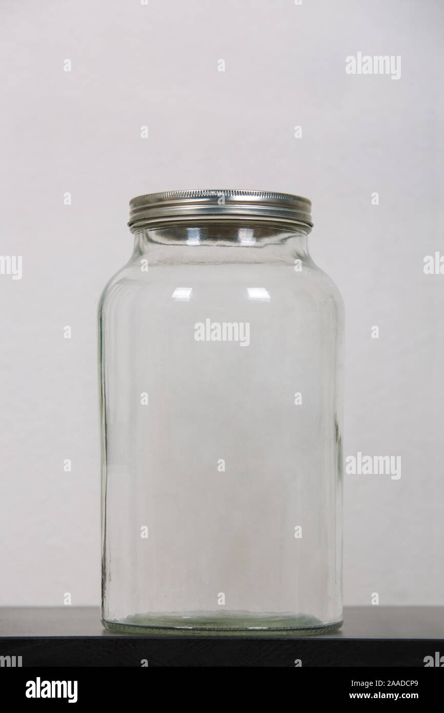Close up photo of an empty jar, on the table, closed with a metal lid ...