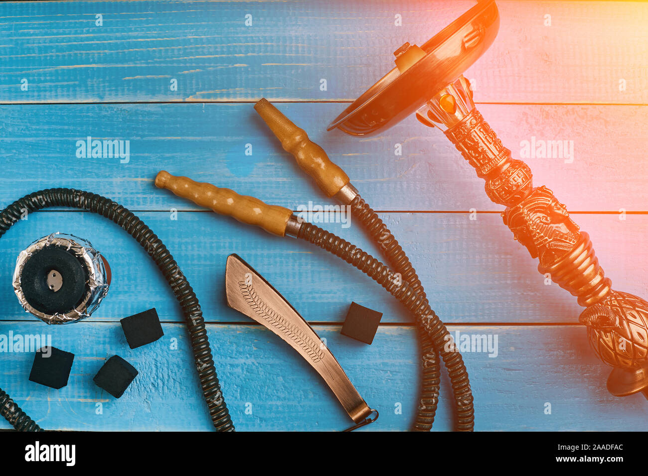 Parts of the hookah on blue wooden background. Hookah accessorie Stock ...