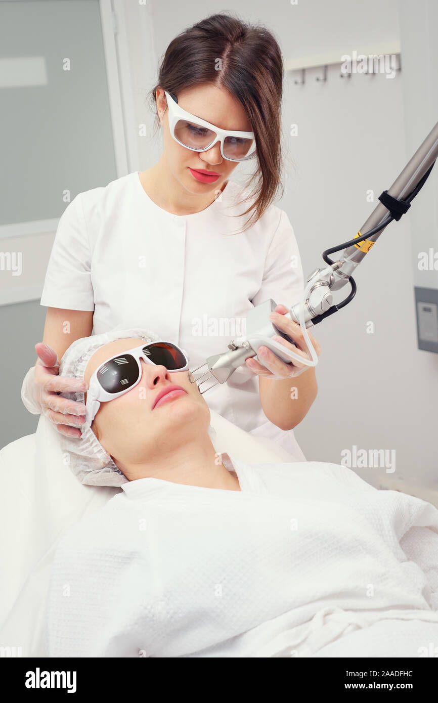 beauty salon girl worker carries out hair removal using latest ...