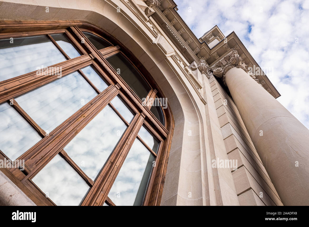 Large historic building with large columns, seen at a low angle, with a ...
