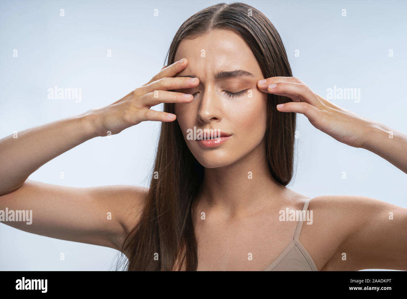 Worried brunette girl keeping her eyes closed Stock Photo - Alamy