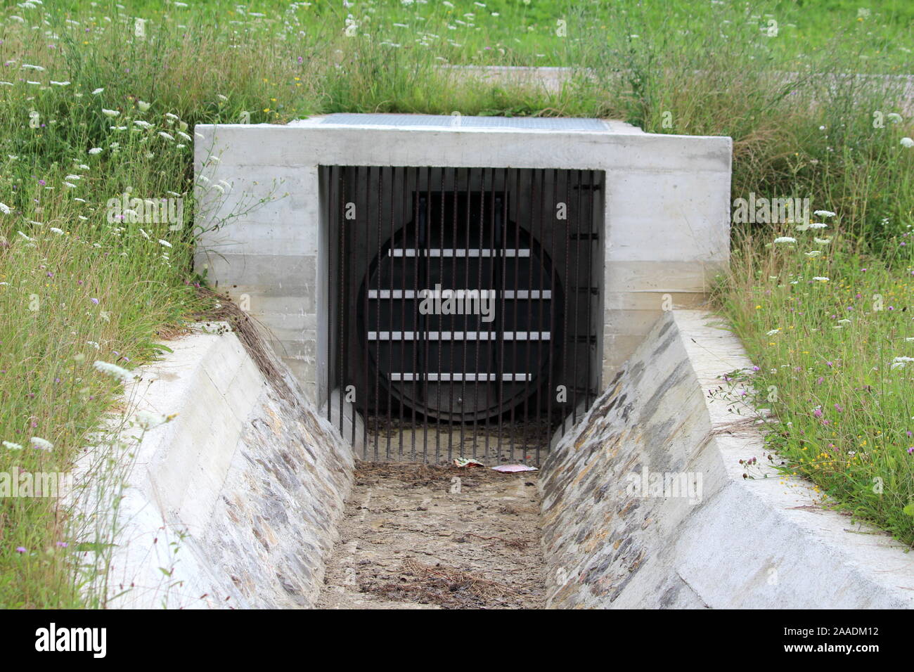 Heavy duty metal bars at local storm drain exit covered with strong ...