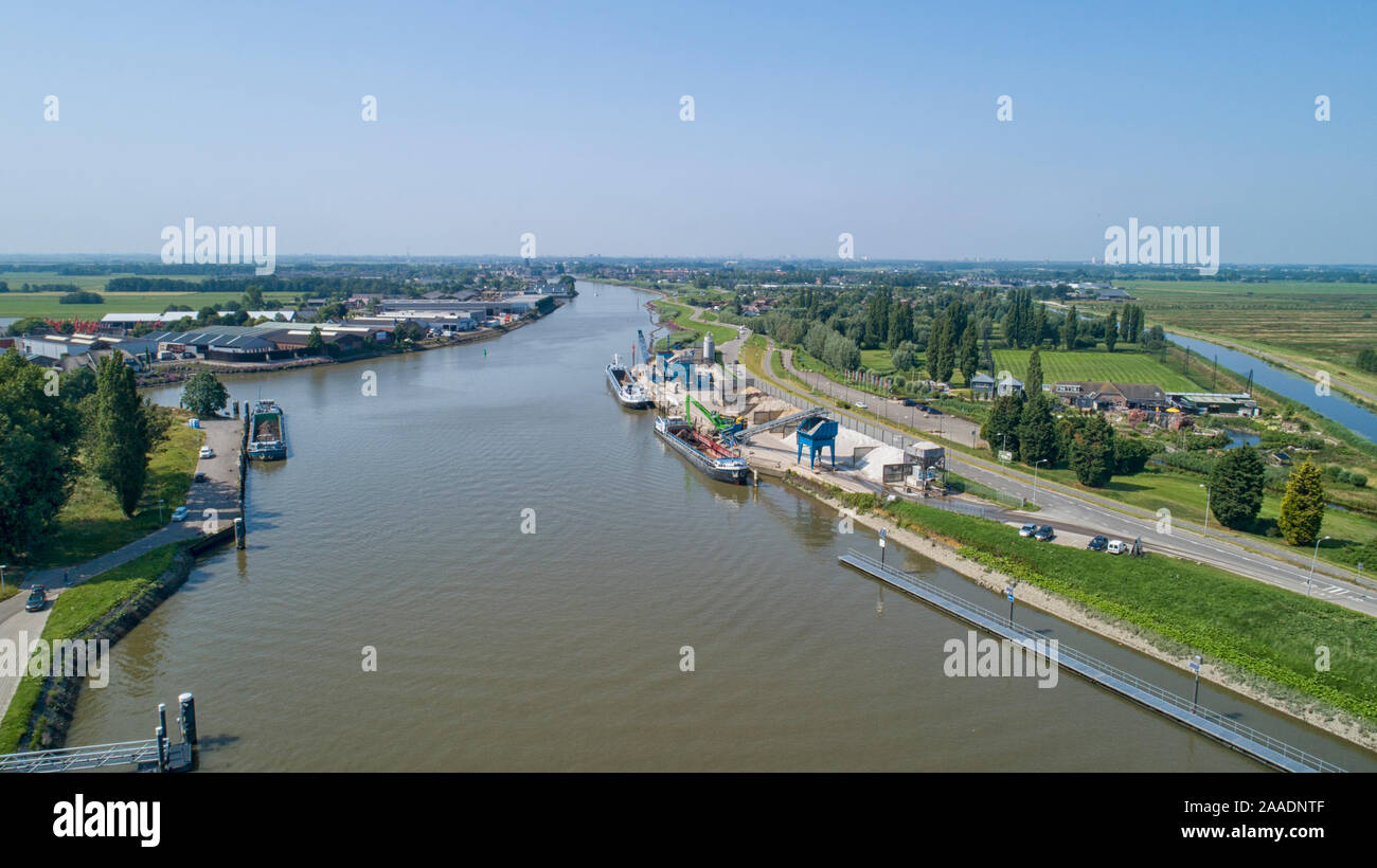 Loading barge with sand and rubble on a small berth. Freight transport ...