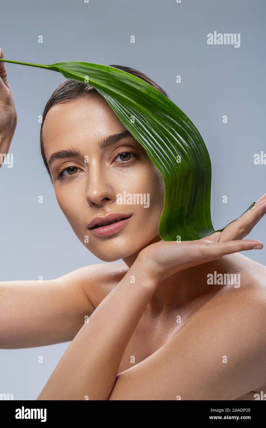 Close up of delighted girl that holding leaf Stock Photo - Alamy