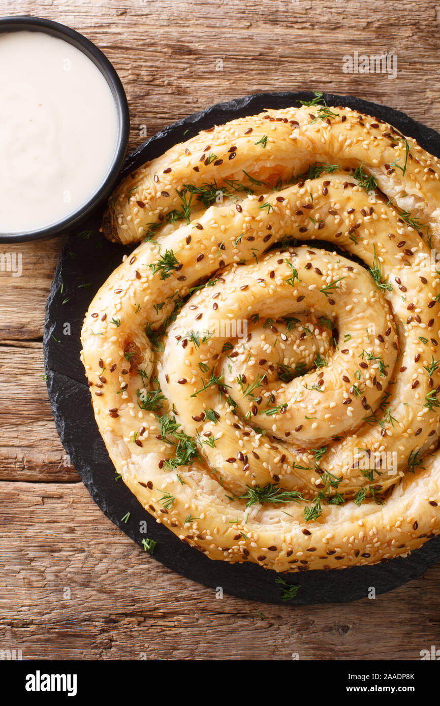Homemade borek (burek) pie with feta cheese close-up on the table ...