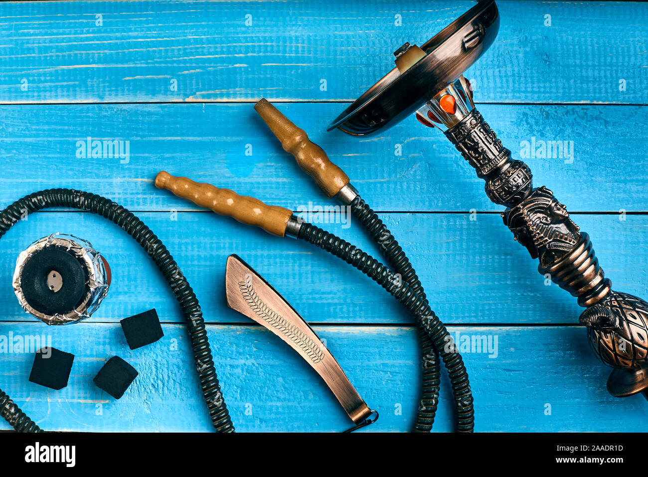 Parts of the hookah on blue wooden background. Hookah accessorie Stock ...