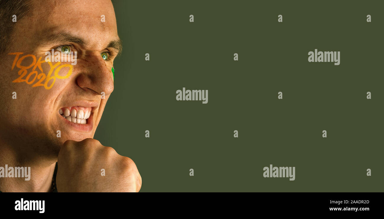 Caucasian young man's close up portrait on green studio background ...