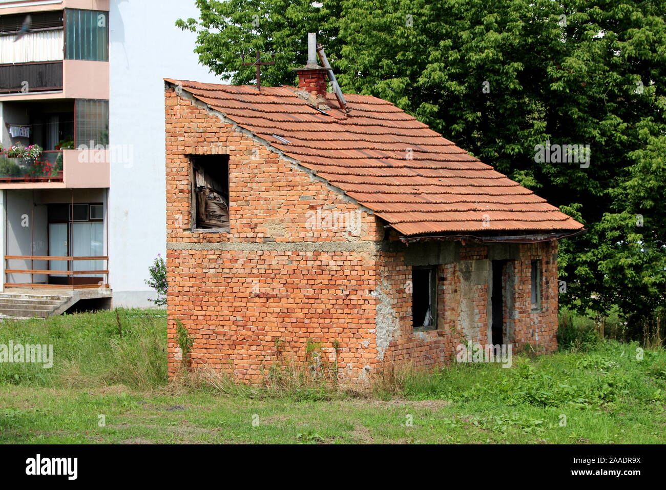 Small abandoned red brick family house with broken missing doors and ...