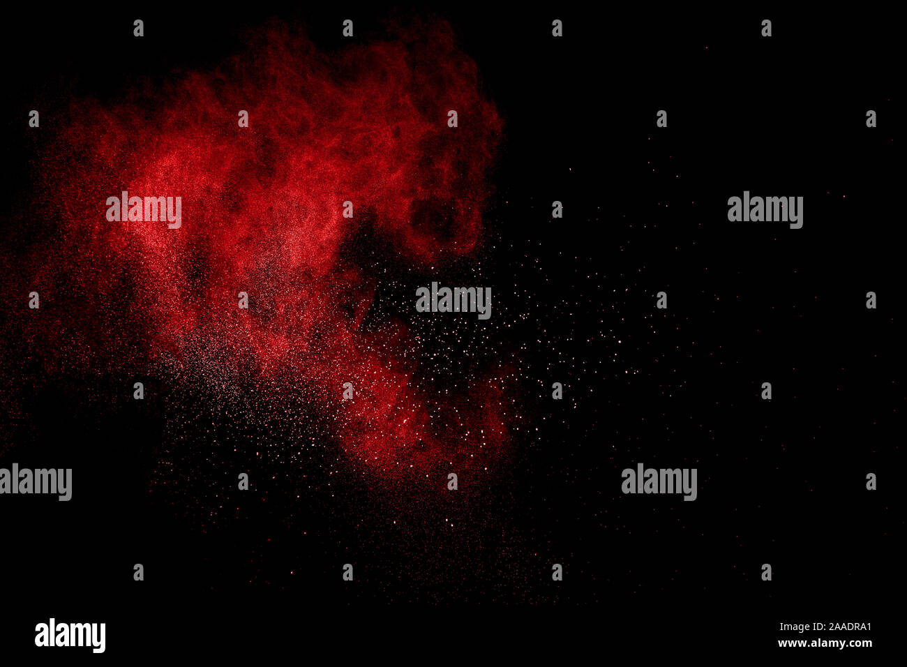 Red powder explosion on black background. Freeze motion of red dust ...