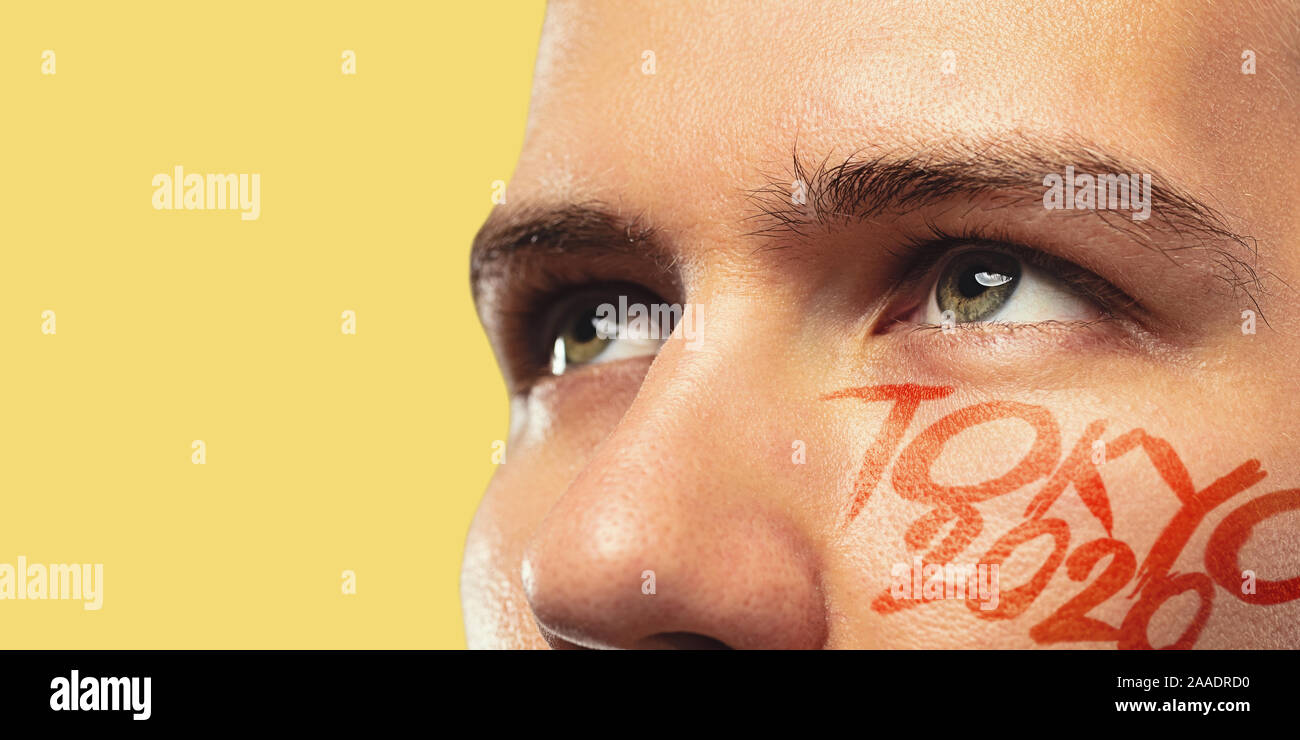 Caucasian young man's close up portrait on yellow studio background ...