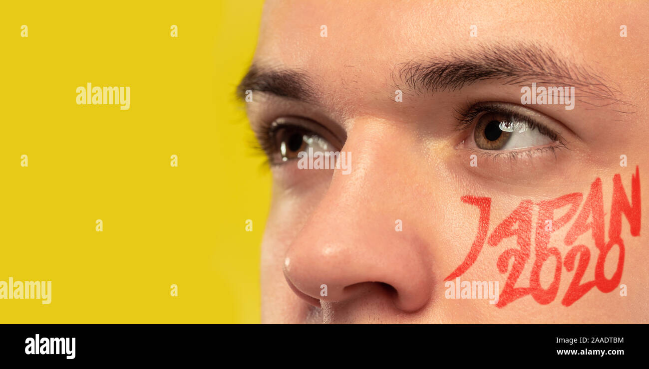Caucasian young man's close up portrait on yellow studio background ...