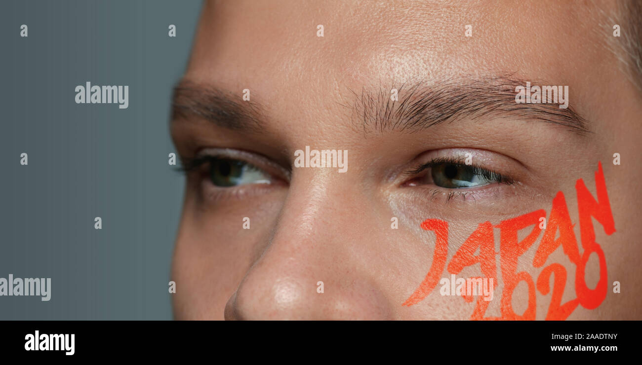 Caucasian young man's close up portrait on grey studio background ...