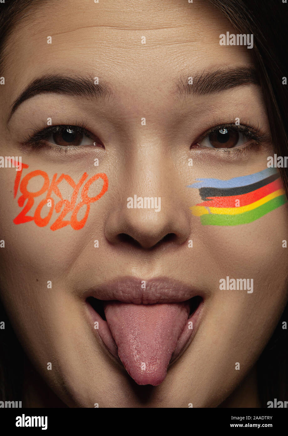 Asian young woman's close up portrait on yellow studio background ...