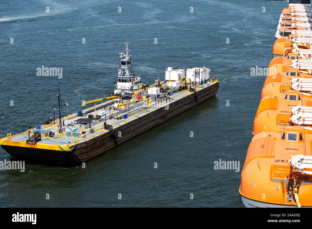 Oil Barge providing "bunker" (fuel for ships engines) to The RMS Queen ...