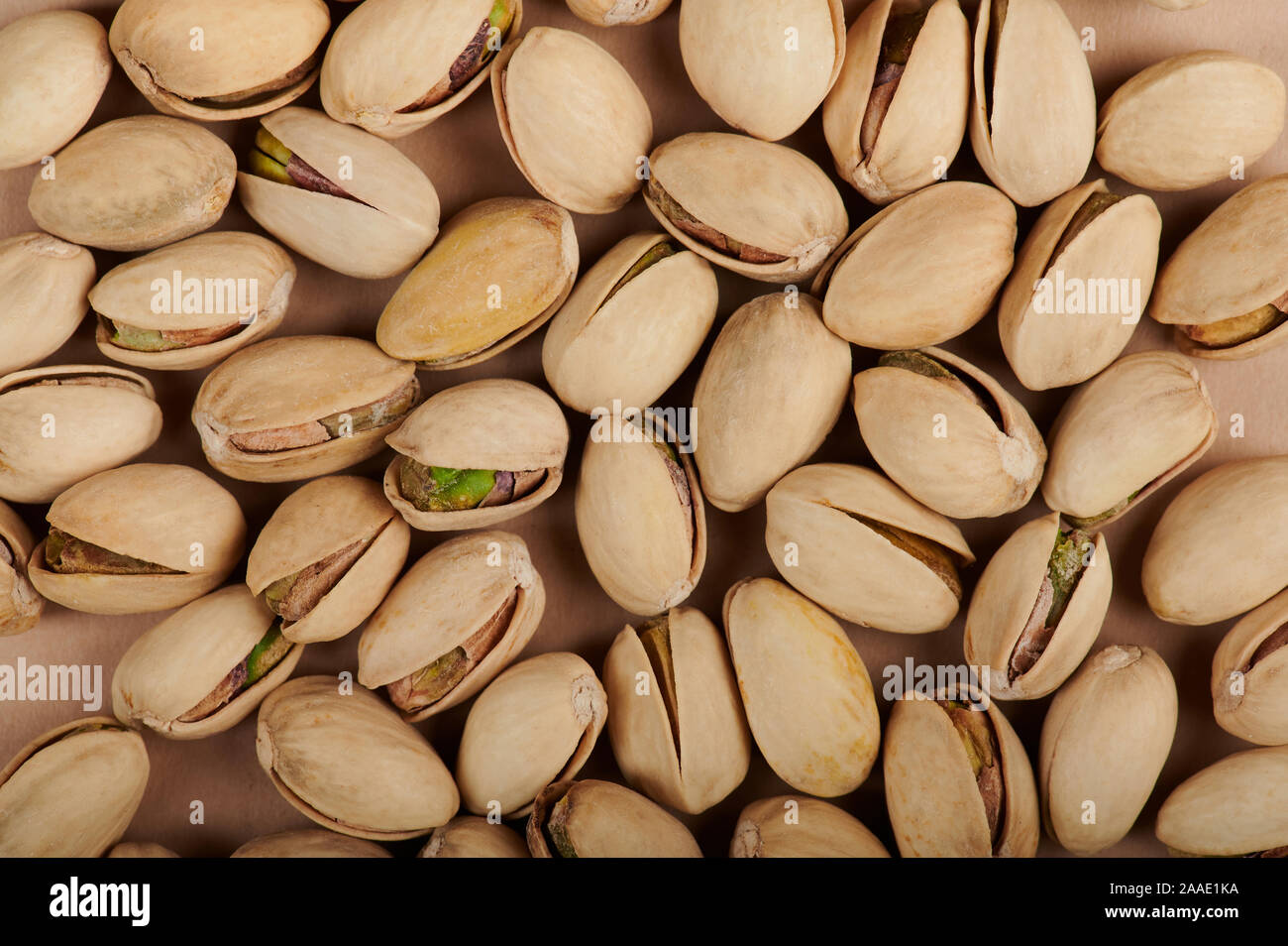Group of dry pistachio nuts on beige color background Stock Photo - Alamy