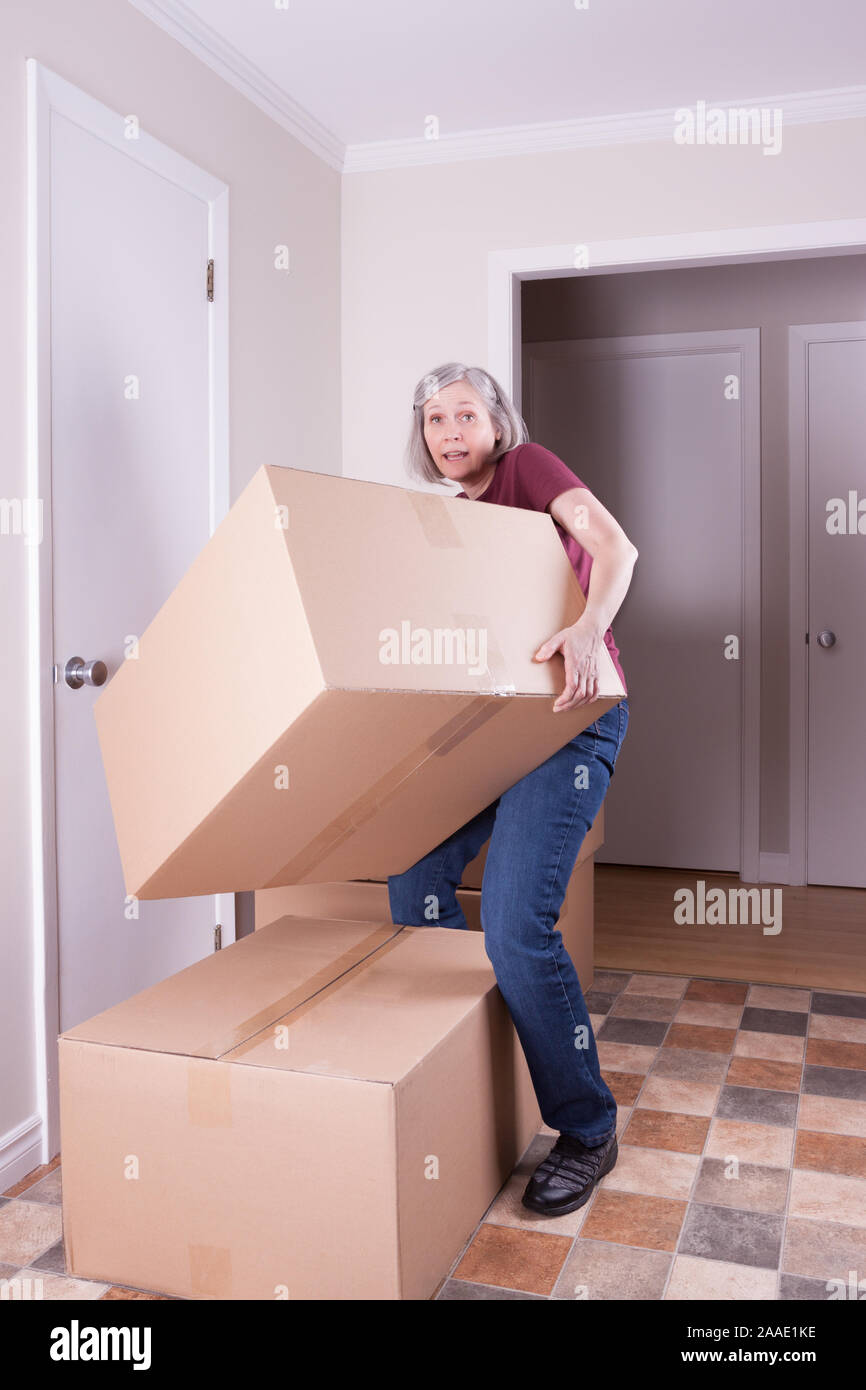 Woman lifting mature boxes hi-res stock photography and images - Alamy
