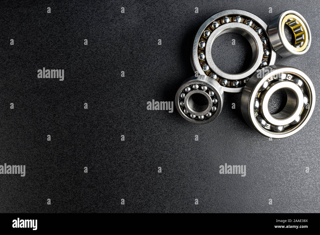 Ball bearing lying on a black background with copy space on the left ...