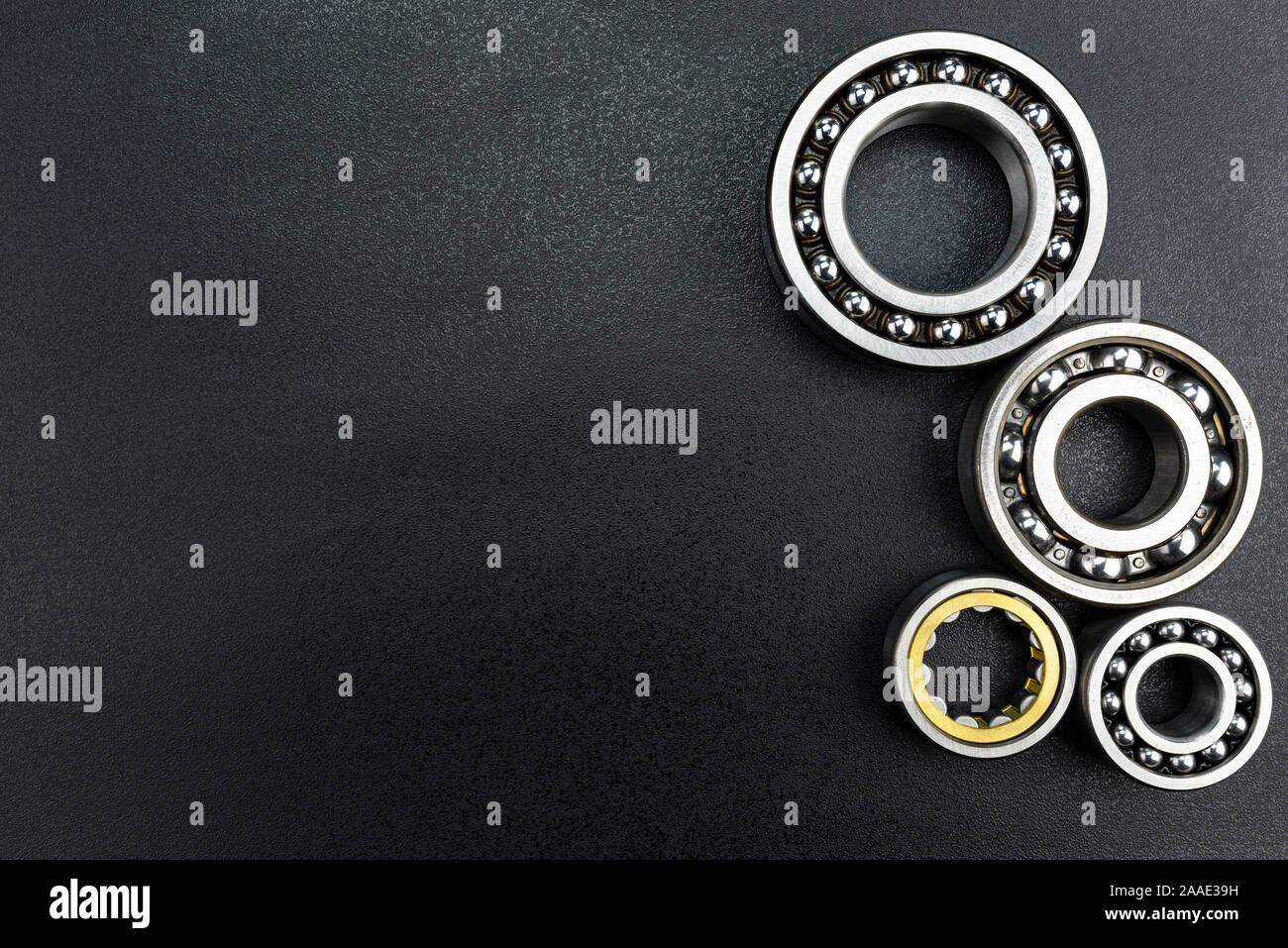 Ball bearing lying on a black background with copy space on the left ...