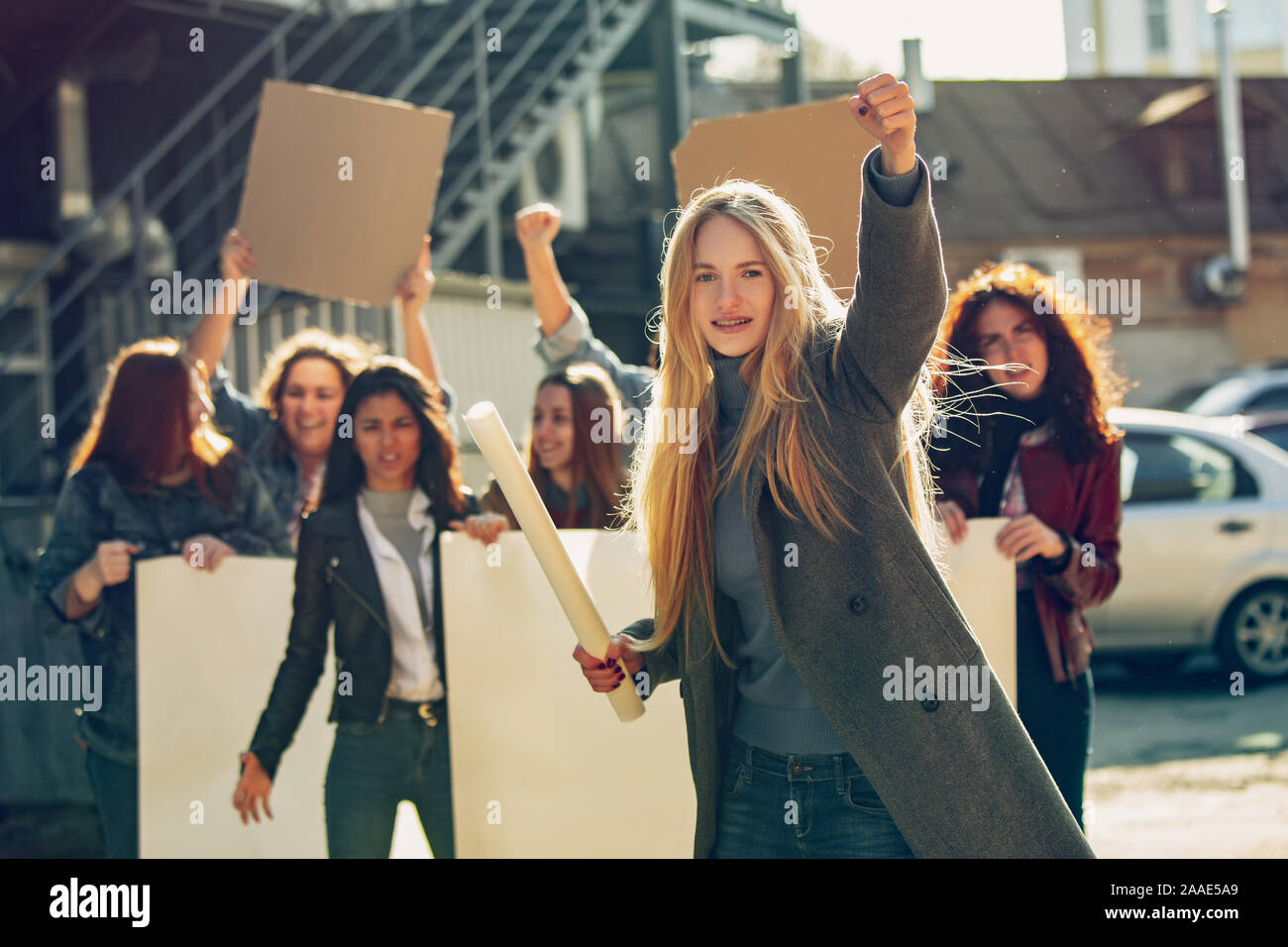 Young woman screaming in front of people protesting about women's ...
