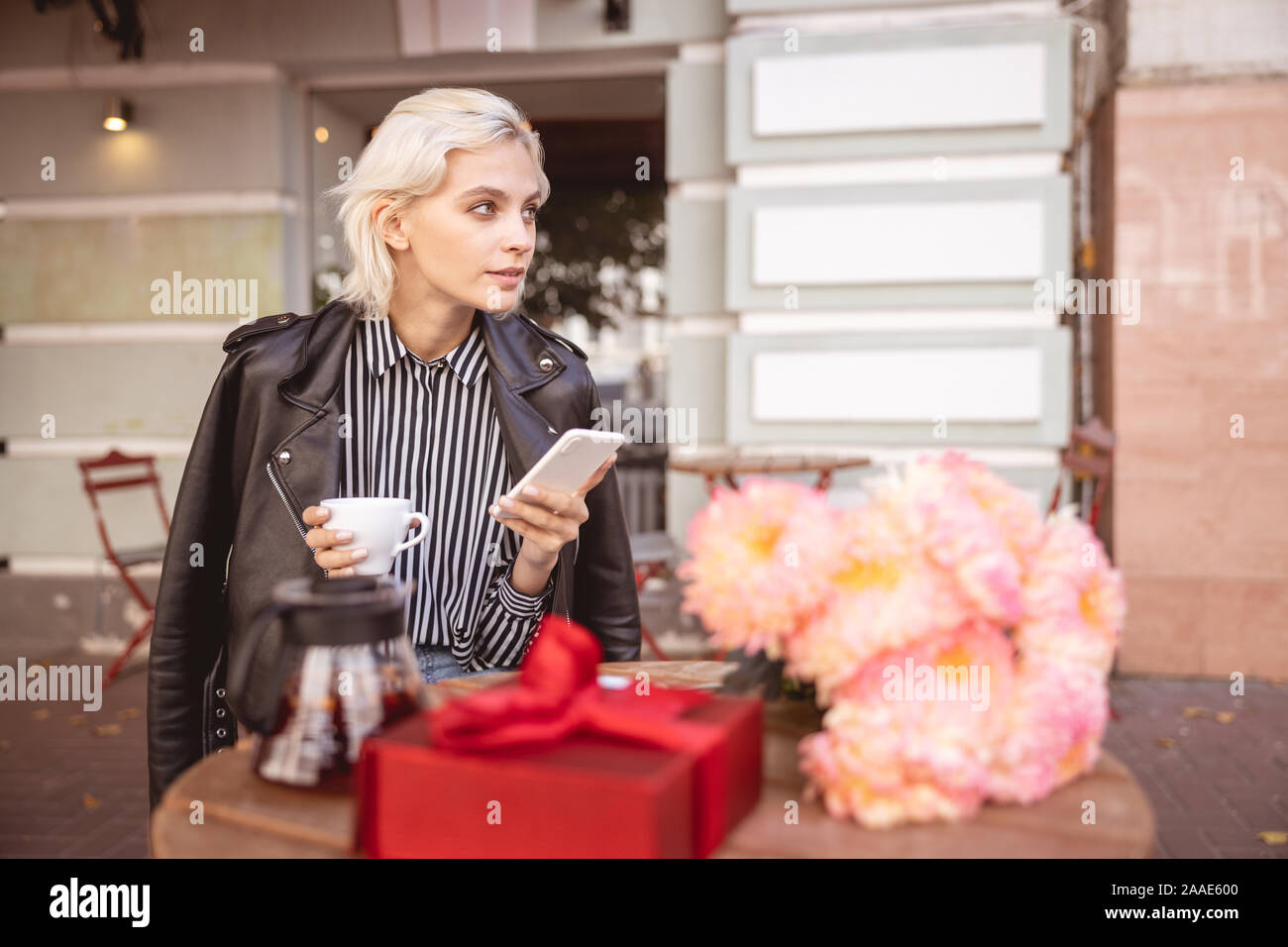 Woman thinking about her reply to incoming message Stock Photo - Alamy