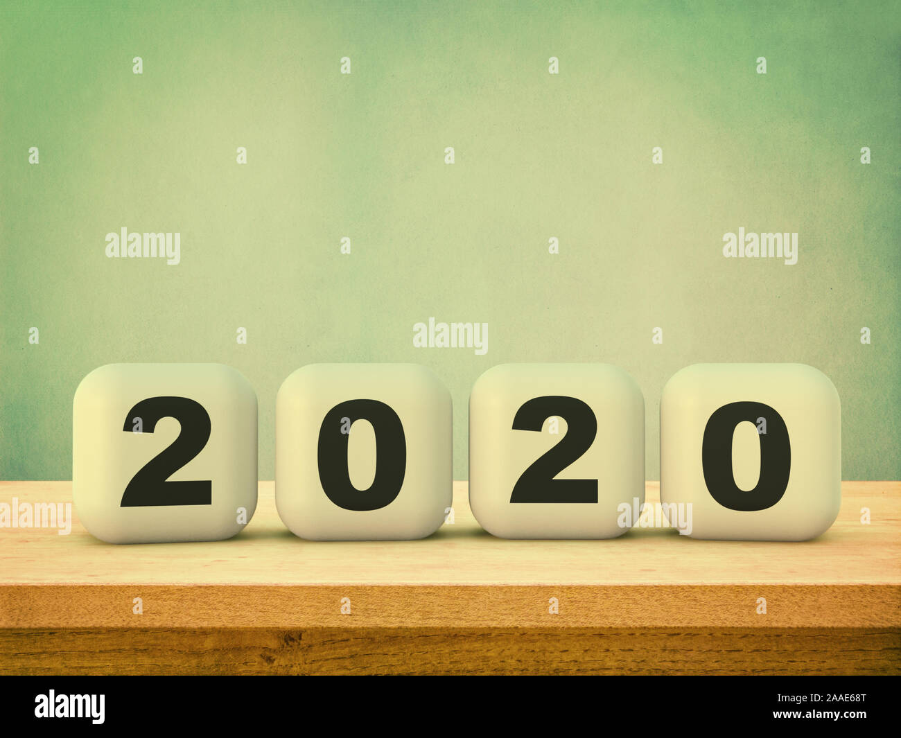 The year 2020 on wooden table against green background, retro colors ...