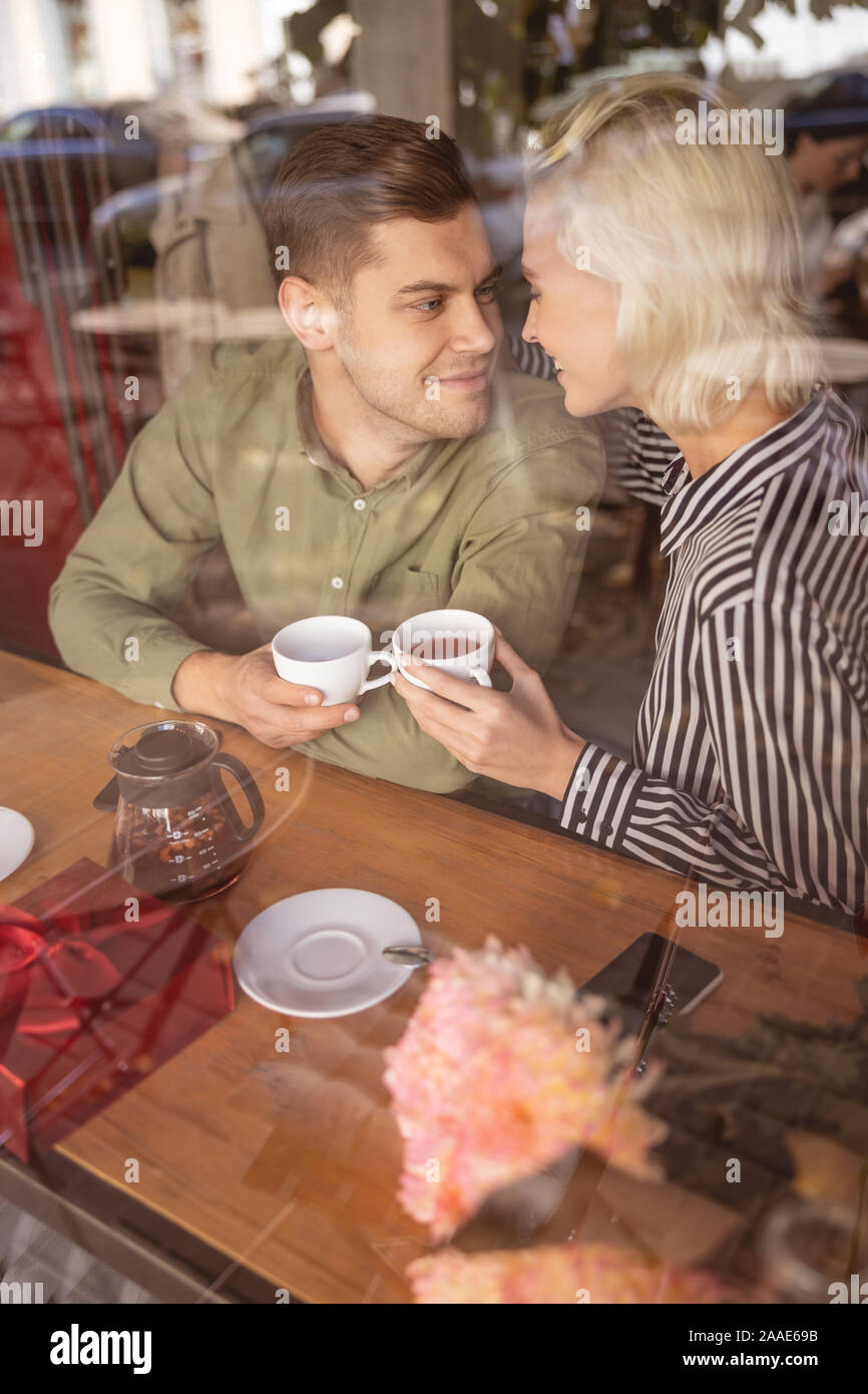 Couple having tea in the small cafe Stock Photo - Alamy