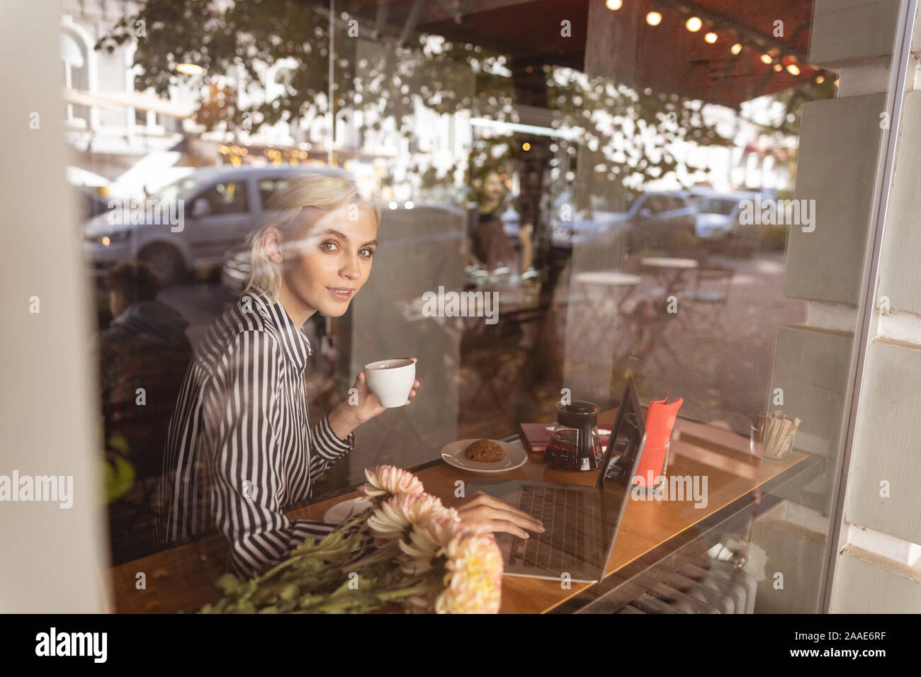 Pretty lady having tea during her work Stock Photo - Alamy