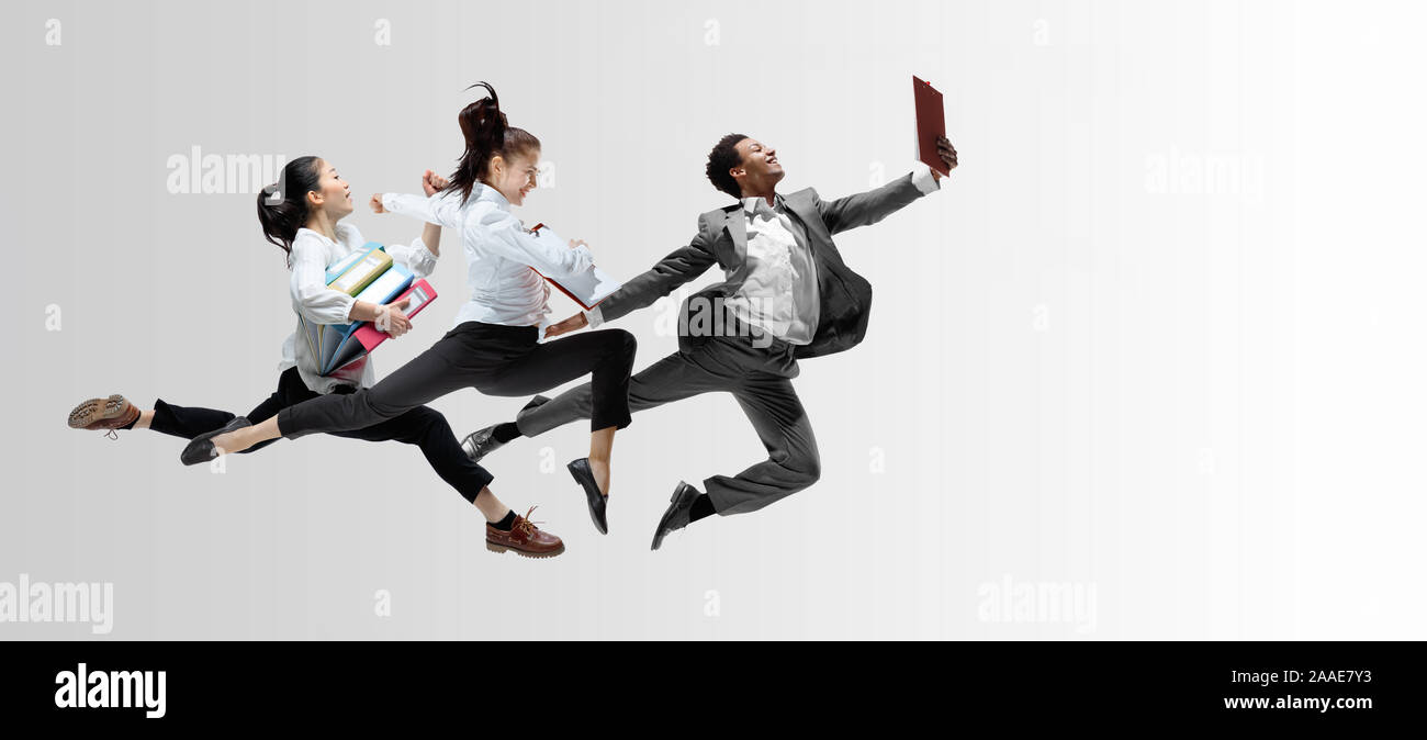 Happy office workers jumping and dancing in casual clothes or suit with ...