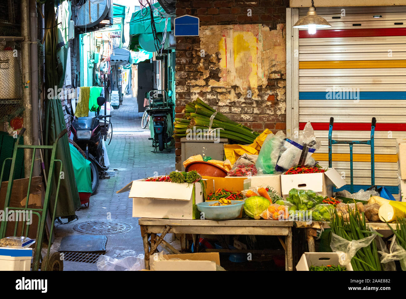 Narrow alley at the vegetable market. Colorful Asian street. Vegetables ...