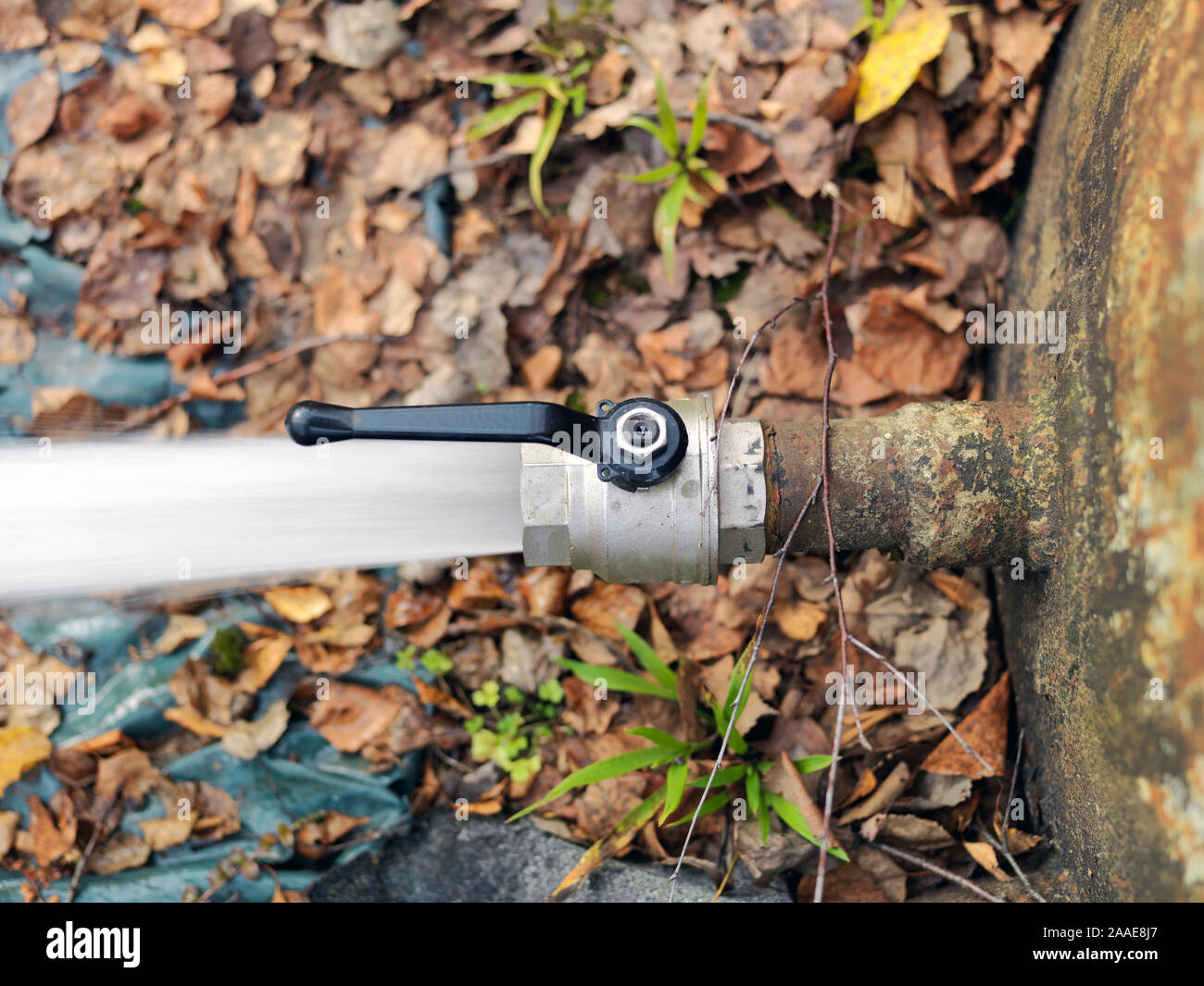 Overhead shot of a water flowing out of the open valve, outdoor image ...
