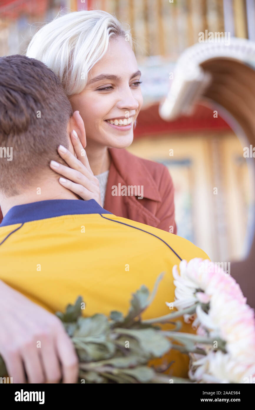 Cheerful woman being glad in arms of her boyfriend Stock Photo - Alamy