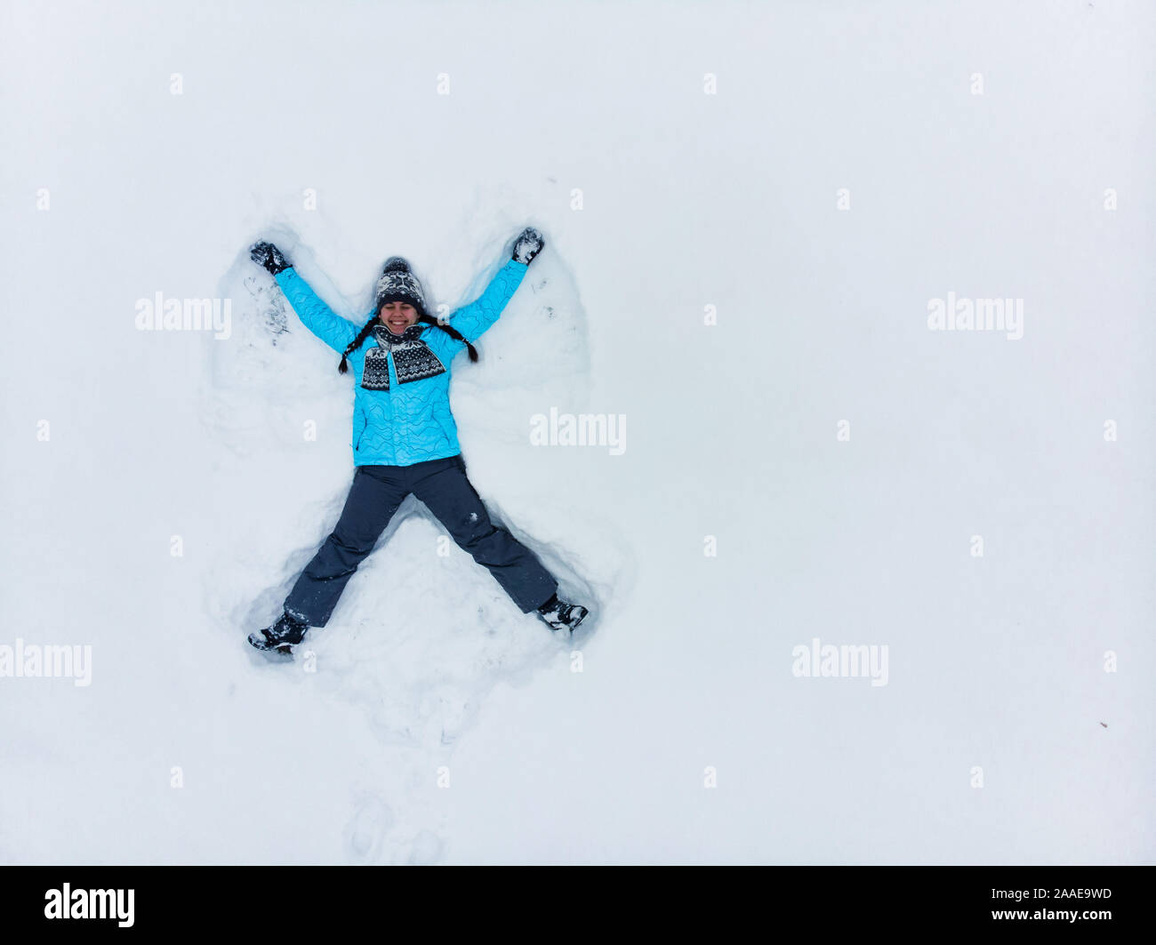 overhead view woman making snow angel Stock Photo - Alamy