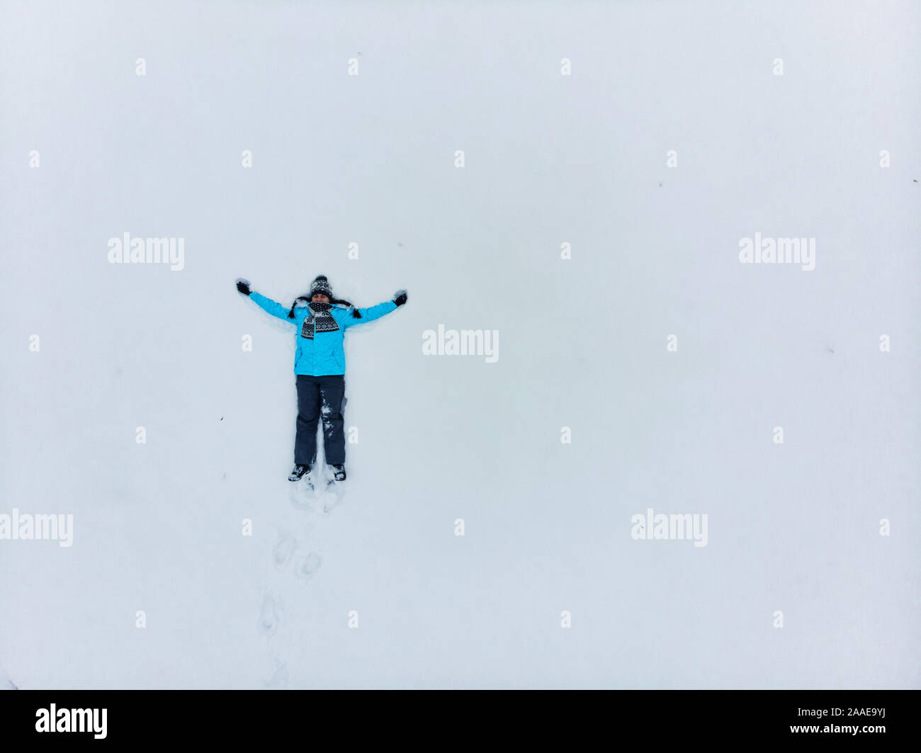 overhead view woman making snow angel Stock Photo - Alamy