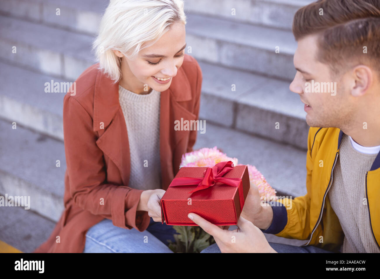 Woman being pleased receiving a birthday gift Stock Photo - Alamy