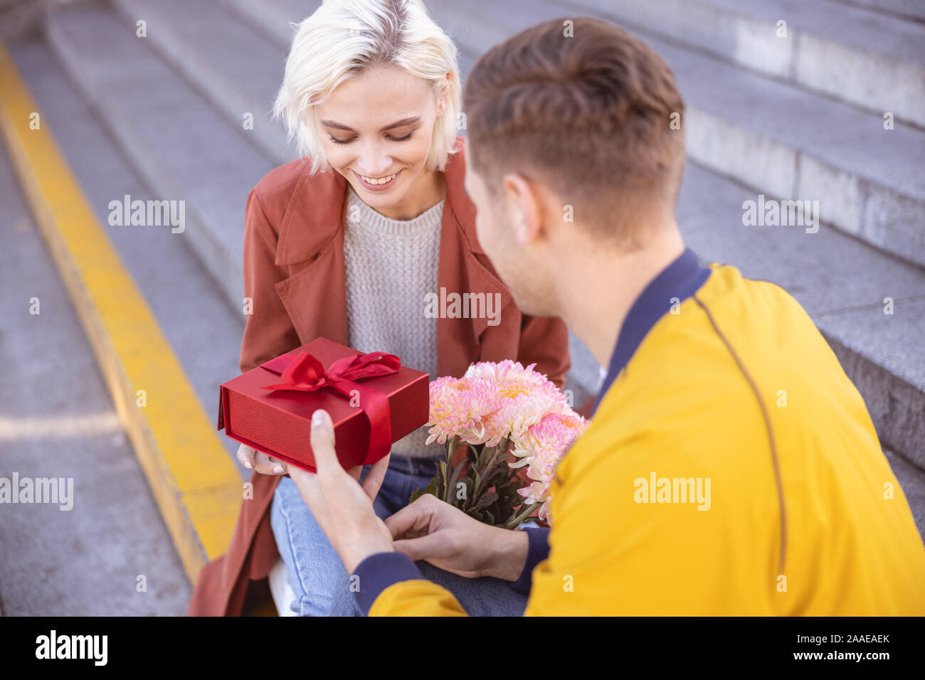 Pretty woman receiving a gift from her beloved man Stock Photo - Alamy