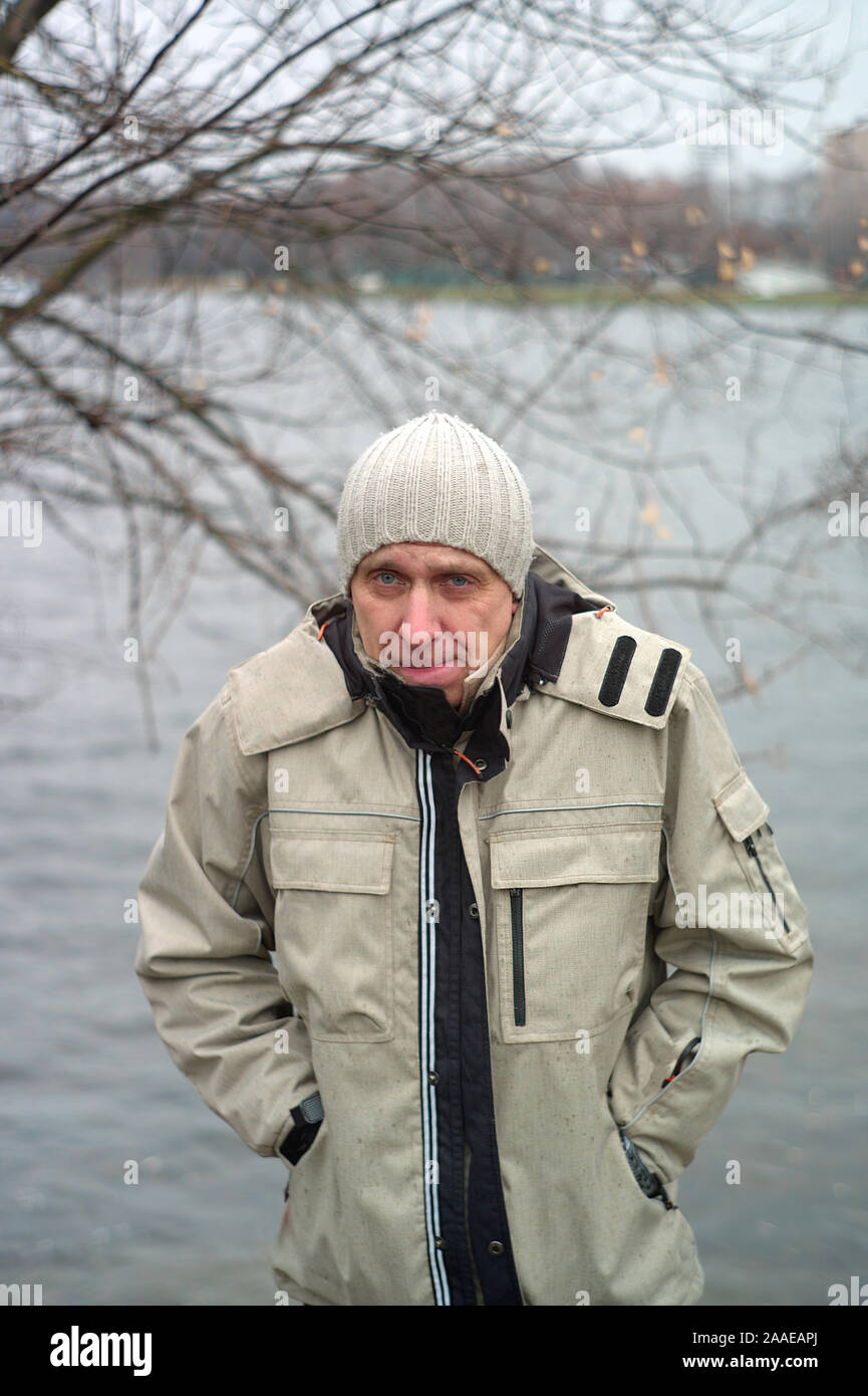 A man huddled from cold, posing outdoor, vertical shot Stock Photo - Alamy