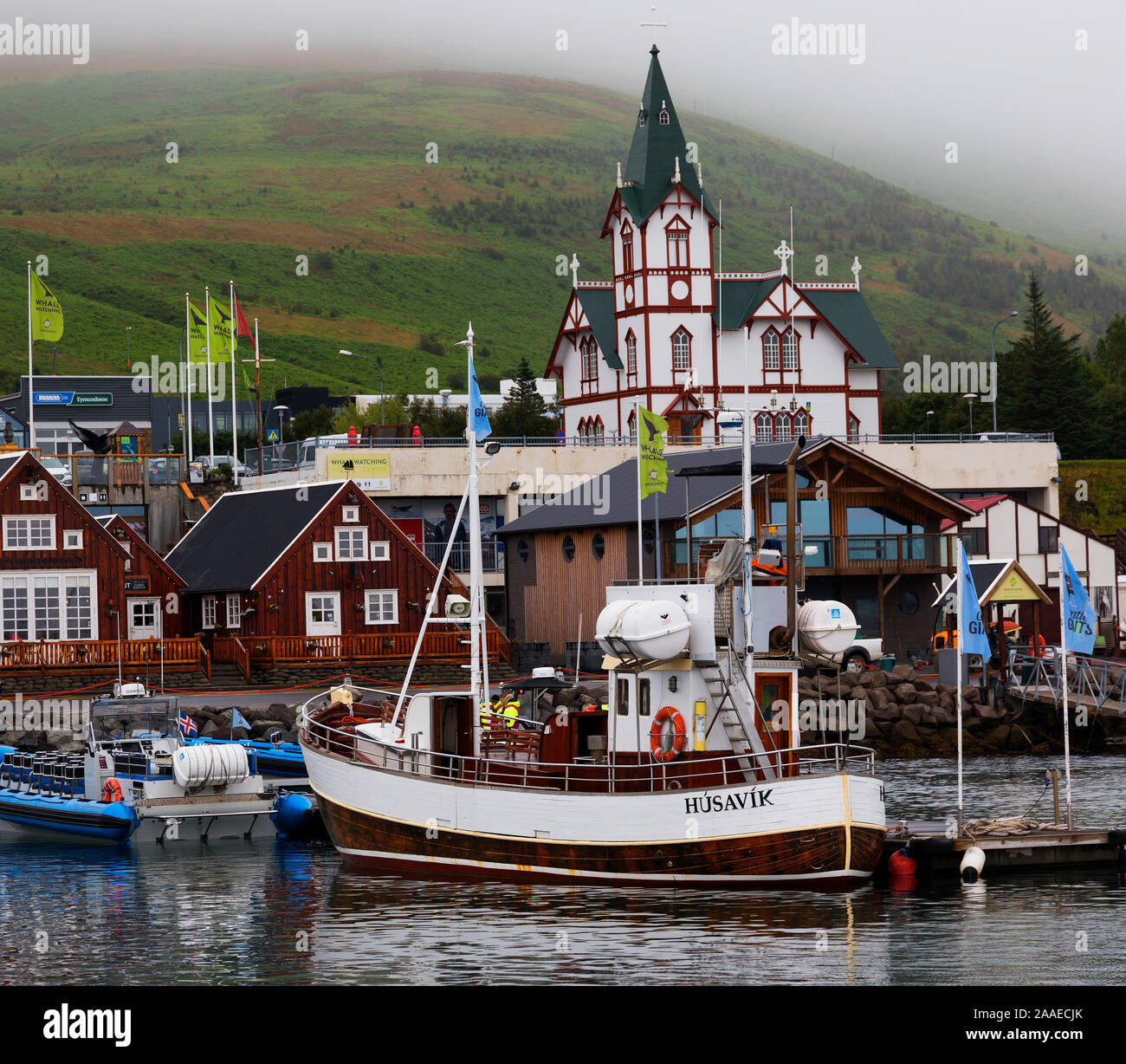 Icelandic Husavik fishing village marina and colorful boats in port in ...