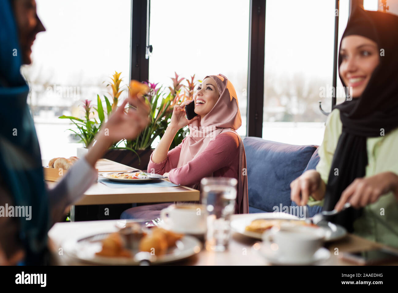 Young muslim woman in the restaurant Stock Photo - Alamy