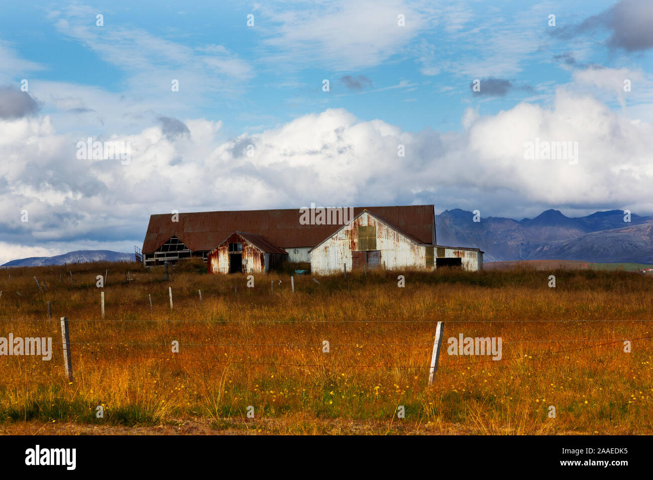 Clouds over farm and field and mountain range in Iceland Stock Photo ...