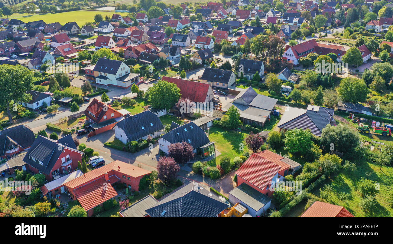 Aerial view of a suburb with detached houses, garden areas, lawns and a ...