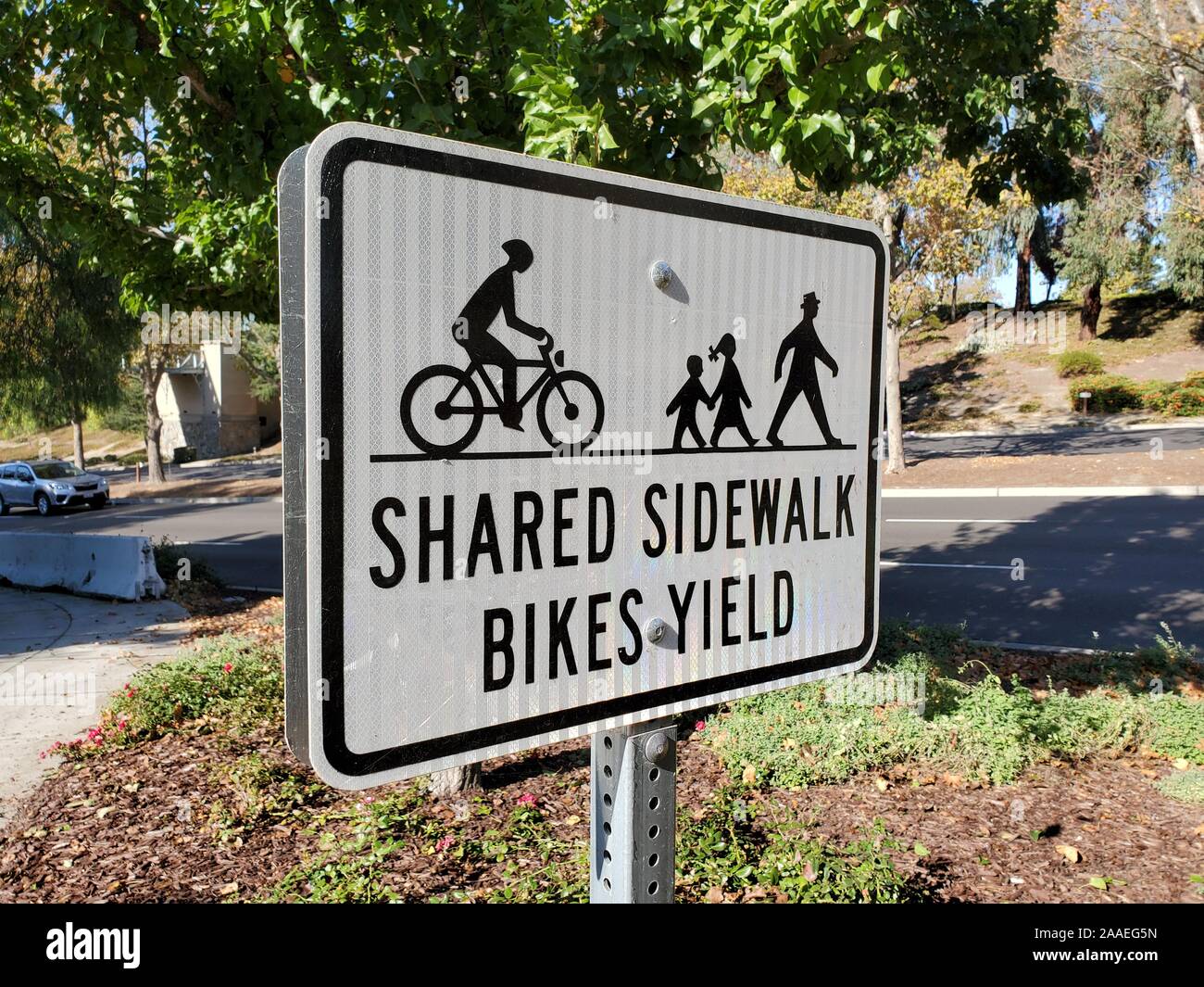 Close-up of sign indicating the presence of a shared sidewalk, designed ...